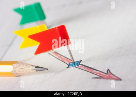 Colorful pins on sketched red arrow points Stock Photo - Alamy