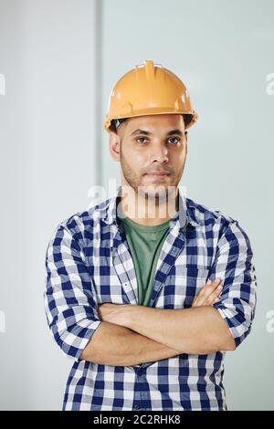 Waist-up portrait of a serious repairman discussing something on the ...