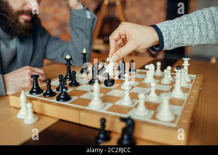 Male chess players, white knight takes pawn Stock Photo - Alamy