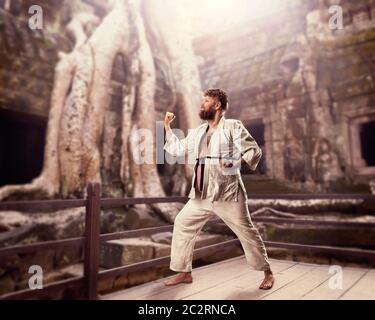 Fat bearded karate fighter in white kimono in the open air Stock Photo ...