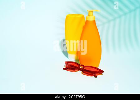 Two orange containers for lotion without label on blue background with ...