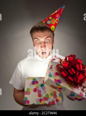Surprised man opening a gift box Stock Photo - Alamy