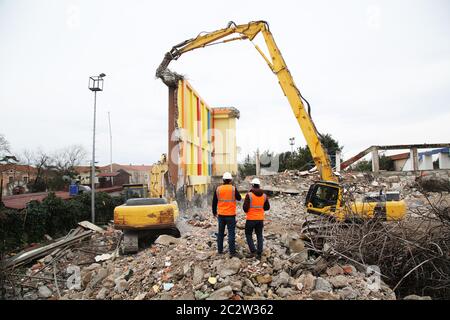 Engineer mans in helmet and jacket controlling outdoor construction ...