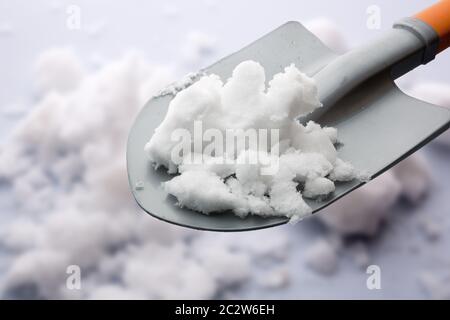 Clean slush snow on shovel closeup, snowy background Stock Photo - Alamy