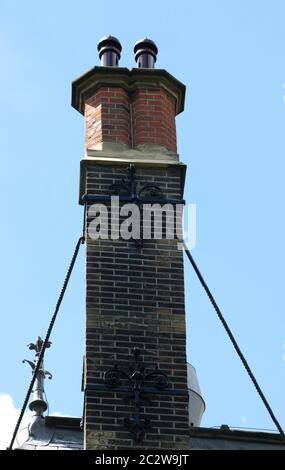 A tall chimney with struts Stock Photo - Alamy