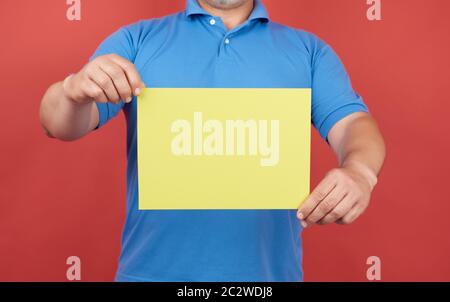 Man with flyer in hand and red background positive gesture model Stock ...