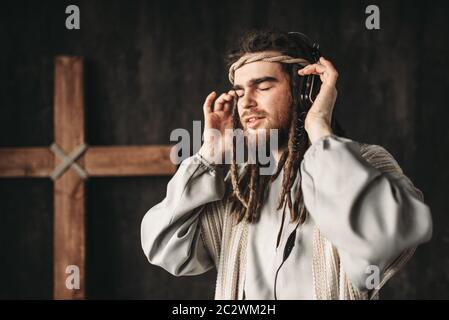 Holy Bible and modern headphones on color background Stock Photo - Alamy