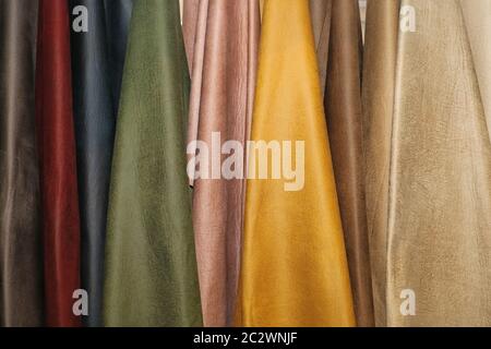 Colorful metallic leather material samples hanging on the wall Stock ...