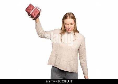 An angry young woman wants to smash her gift with a hammer Stock Photo ...