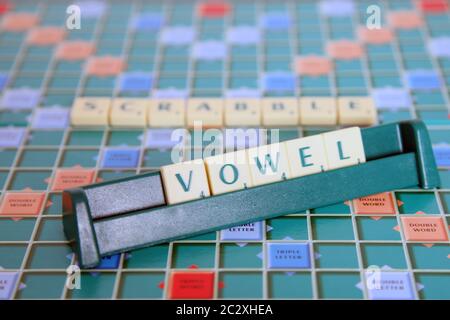 Scrabble letters tiles in rack - Vowels A E I O U AEIOU Stock Photo - Alamy