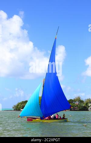 Image showing a boat locally known as "pirogue", with a colorful sail ...