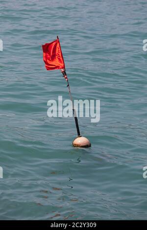 Floating Red Flag Mark in Harbour Water Warning Stock Photo - Alamy
