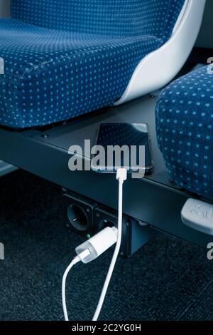Charging phone on the train Stock Photo - Alamy