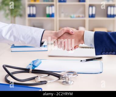 Man signing medical insurance contract Stock Photo - Alamy