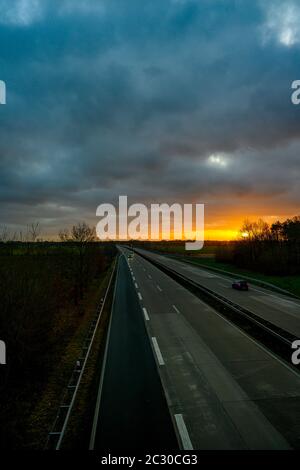 highway in the evening with sunset Stock Photo - Alamy