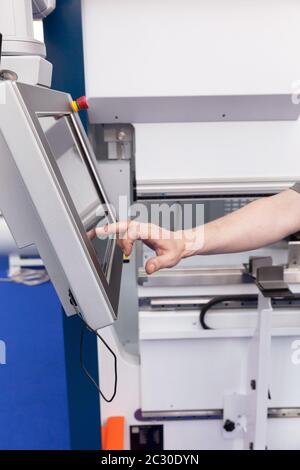 Man working at programmable CNC machine Stock Photo - Alamy