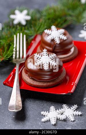Plate with tasty Christmas cake and decorations on pink background ...