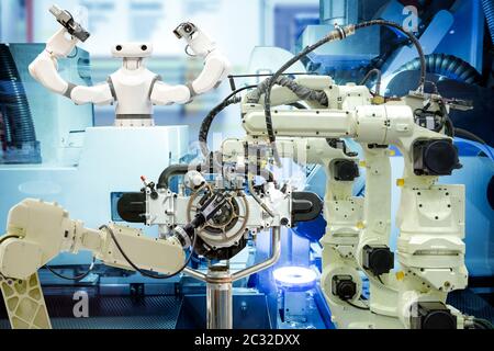 Industrial robotics teamwork on working with CNC lathe machine in smart ...