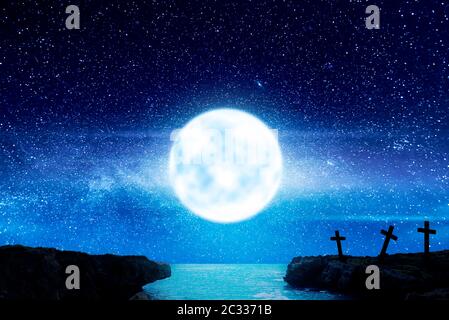Christian Cross on the beach with moonlight background Stock Photo - Alamy