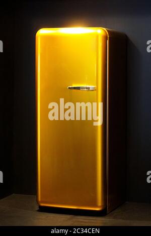 Retro style golden fridge in black kitchen Stock Photo - Alamy