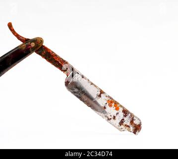 Vintage straight razor with wooden handle isolated on wooden background ...