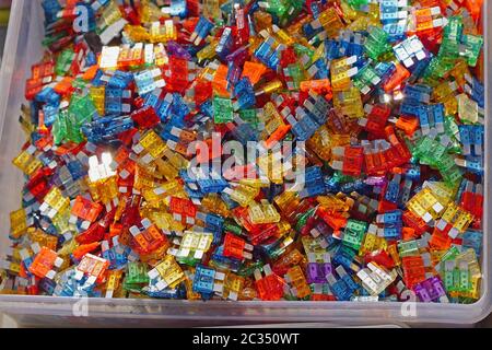 Many color coded fuses for cars in box Stock Photo - Alamy
