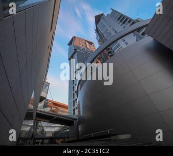 Two modern high rise residential buildings with numerous windows and ...