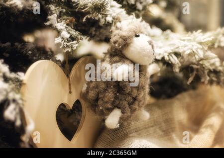 Toy sheep decoration for Christmas on green background Stock Photo - Alamy
