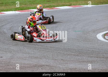 Kart racers navigating the corner on the race track Stock Photo - Alamy