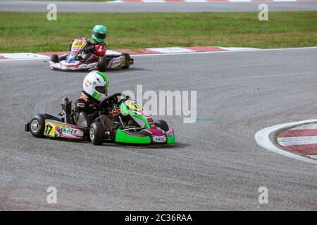 Kart racers navigating the corner on the race track Stock Photo - Alamy