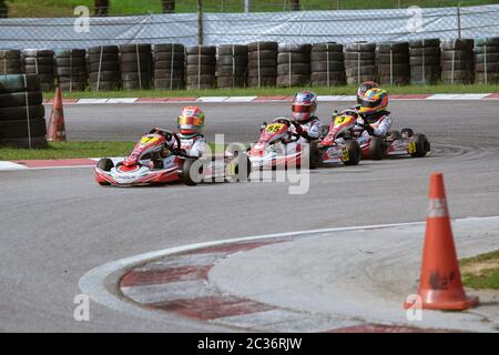 Kart racers navigating the corner on the race track Stock Photo - Alamy