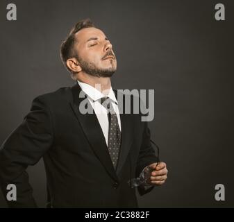 meditation concept - tired man sitting on sofa in yoga pose Stock Photo ...