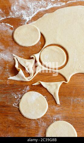 Cutting dough into small circles for dumplings top view Stock Photo - Alamy