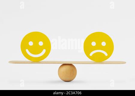 Smiley face and sad face on scale - Concept of sadness as predominant ...