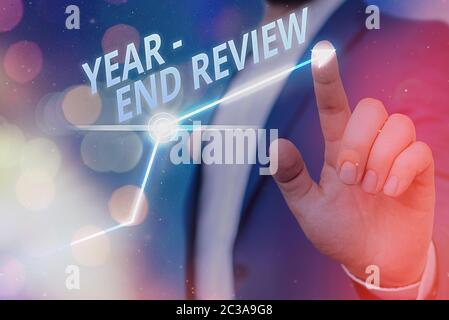 Writing note showing Year end Review. Business concept for annual assessment of achievement and ...