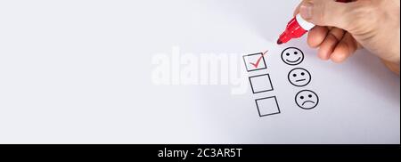 Satisfied customer putting check mark with green marker on five star ...