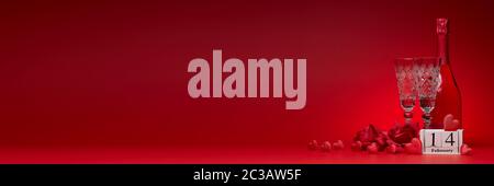 Calendar, bottle of wine, glass and rose flowers on black table ...