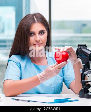 Young nurse woman working at pain recovery clinic clueless and confused ...