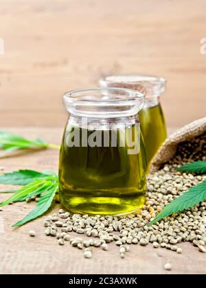 hemp oil in jars close-up. On a wooden background. Selective focus ...