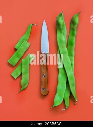 Piattoni green beans with knife on the old wooden table Stock Photo - Alamy