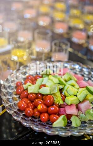 A closeup of a buffet table with fresh watermelon. melon. and pineapple ...