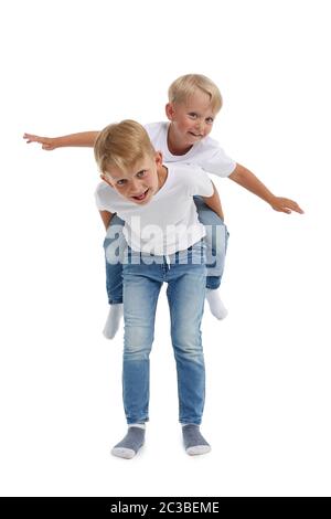 Boy carrying his friend on his back, piggyback Stock Photo - Alamy