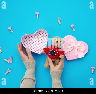 Hand holding a red clothespin on a white background Stock Photo - Alamy