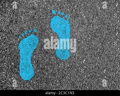 Blue footprint signs on an asphalt road for pedestrian. Symbol of ...