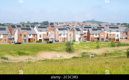 Newly build houses with solar panels attached on the roof against a ...
