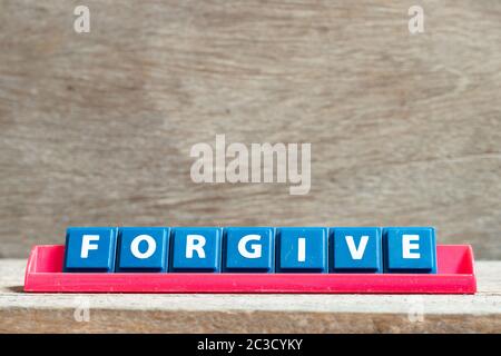 Tile alphabet letter with word empathy in red color rack on wood ...