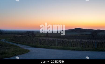 Boulder on a hill before sunrise with coloured sky Stock Photo - Alamy