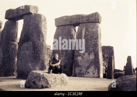Girl sitting on a stone at Stone Henge England UK girl on stone in ...