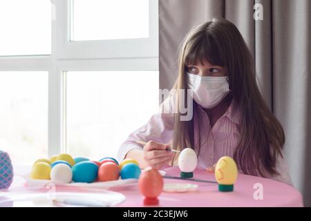 The sick girl alone paints Easter eggs for the holiday Stock Photo - Alamy