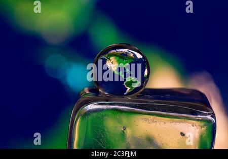 Earth in water drop reflection under green leaf, Elements of this image ...